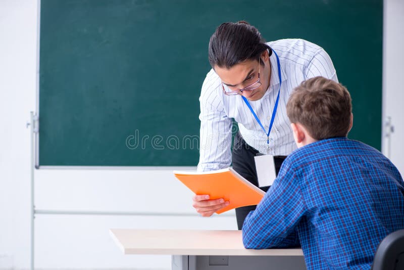 Young Male Teacher and Boy in the Classroom Stock Photo - Image of ...