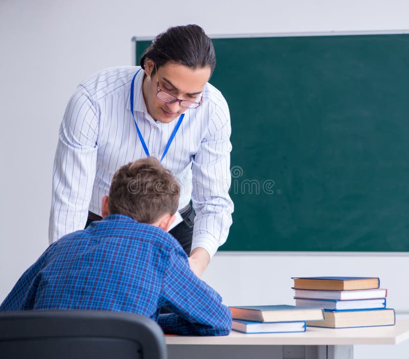 Young Male Teacher and Boy in the Classroom Stock Photo - Image of ...