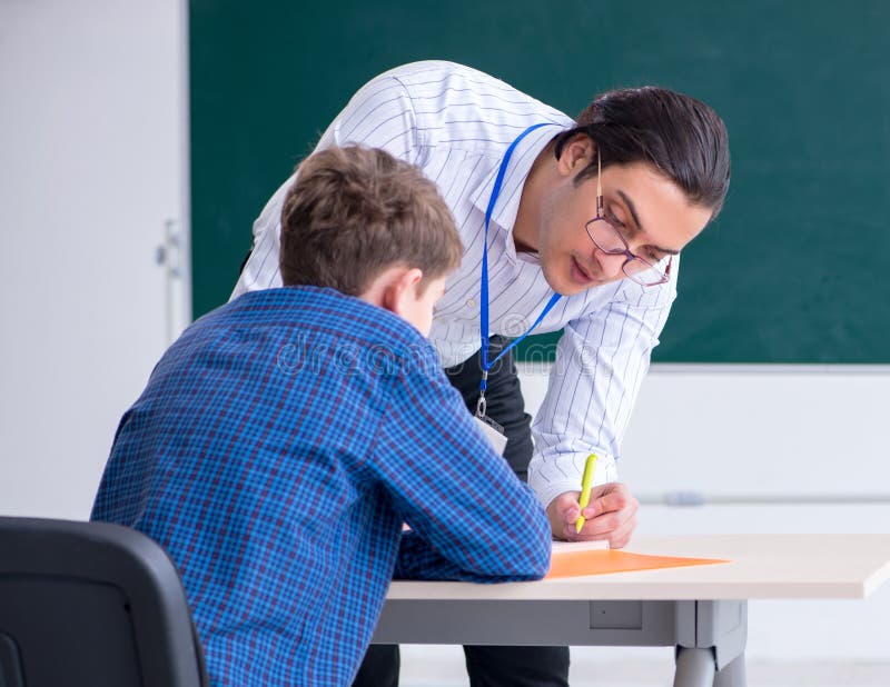 Young Male Teacher and Boy in the Classroom Stock Photo - Image of ...