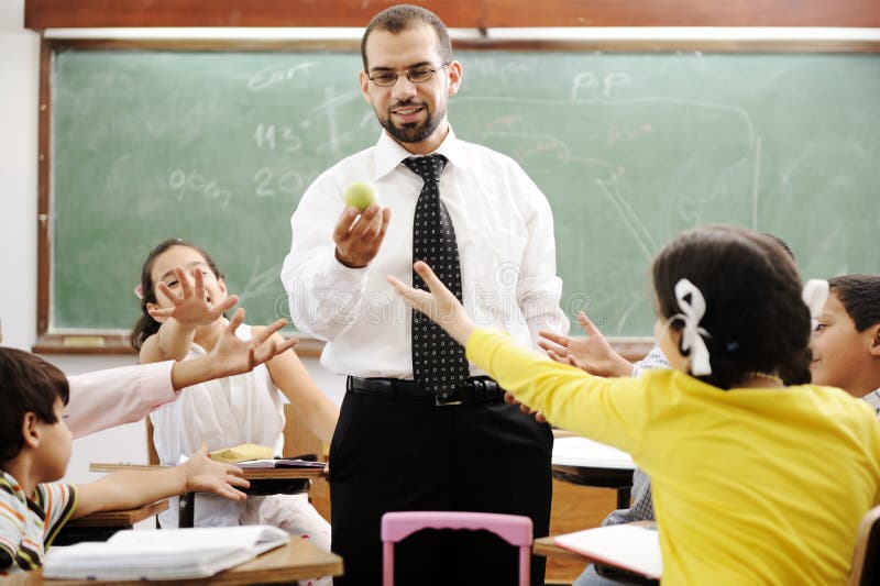 Young Male Teacher with Children Stock Photo - Image of paper, busy ...