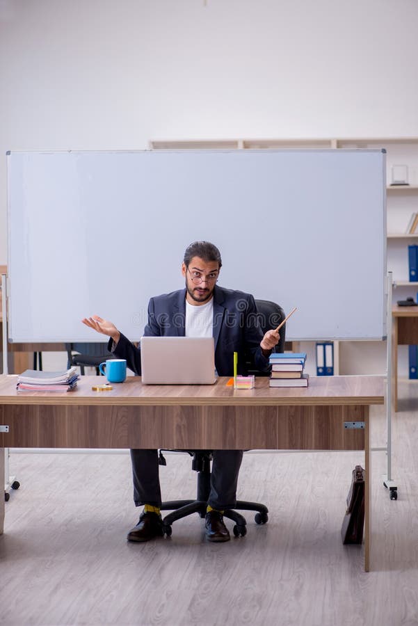 Young Male Teacher in the Classroom Stock Photo - Image of teaching ...