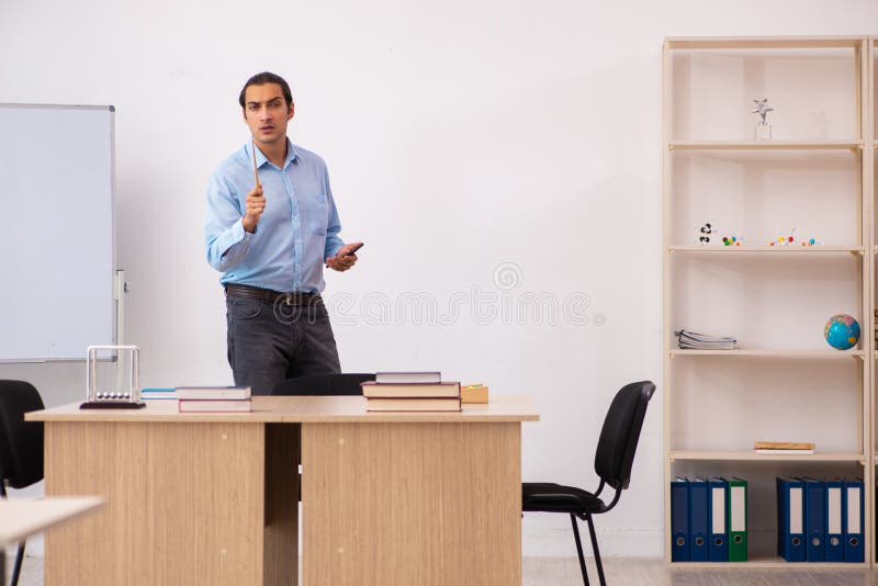Young Male Teacher in the Classroom Stock Photo - Image of pointing ...