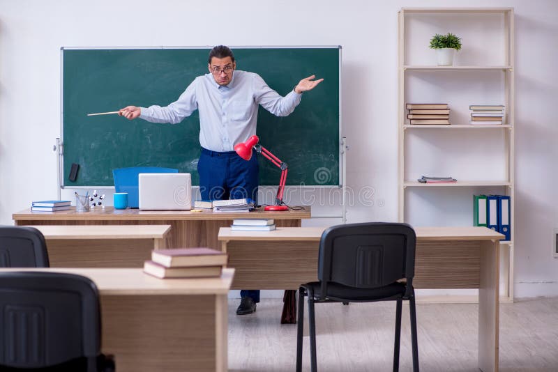 Young Male Teacher in Front of Green Board Stock Photo - Image of ...