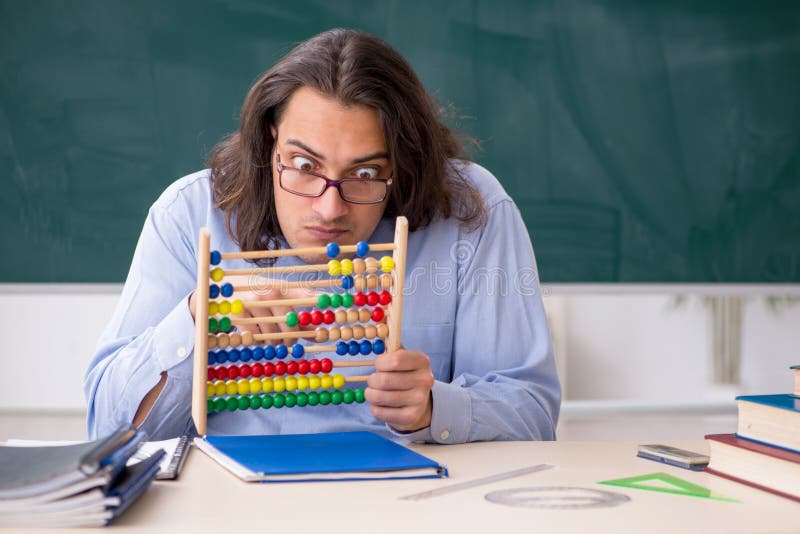 Young Male Teacher in Front of Green Board Stock Image - Image of ...
