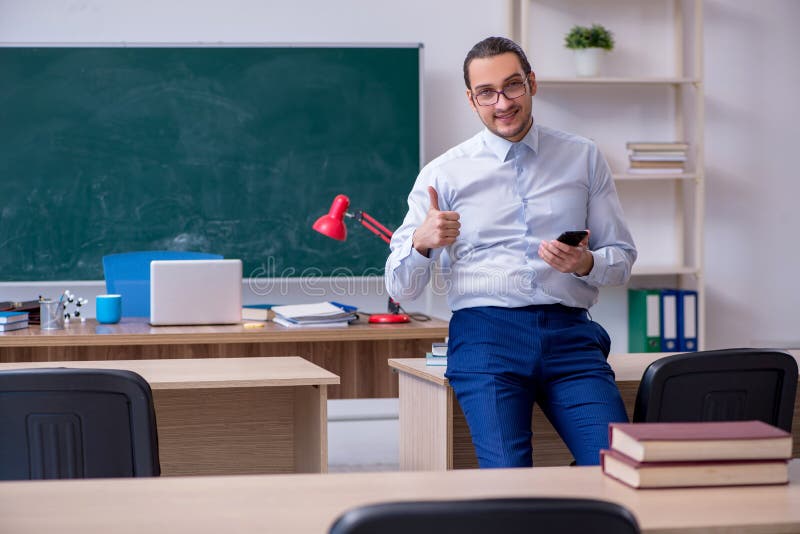 Young Male Teacher in Front of Green Board Stock Image - Image of ...
