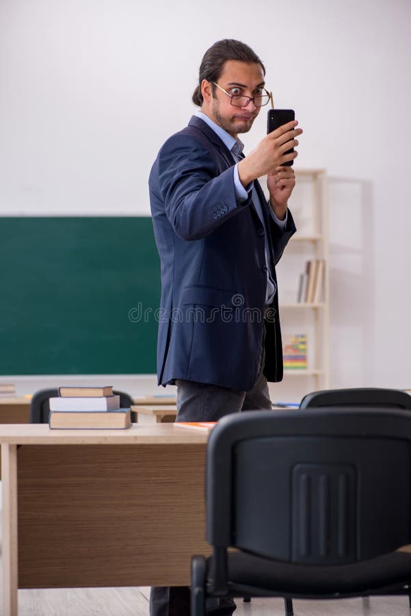 Young Male Teacher in Front of Green Board Stock Photo - Image of ...