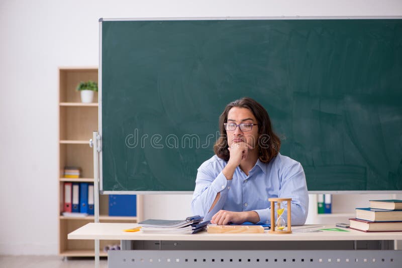 Young Male Teacher in Front of Green Board Stock Image - Image of ...