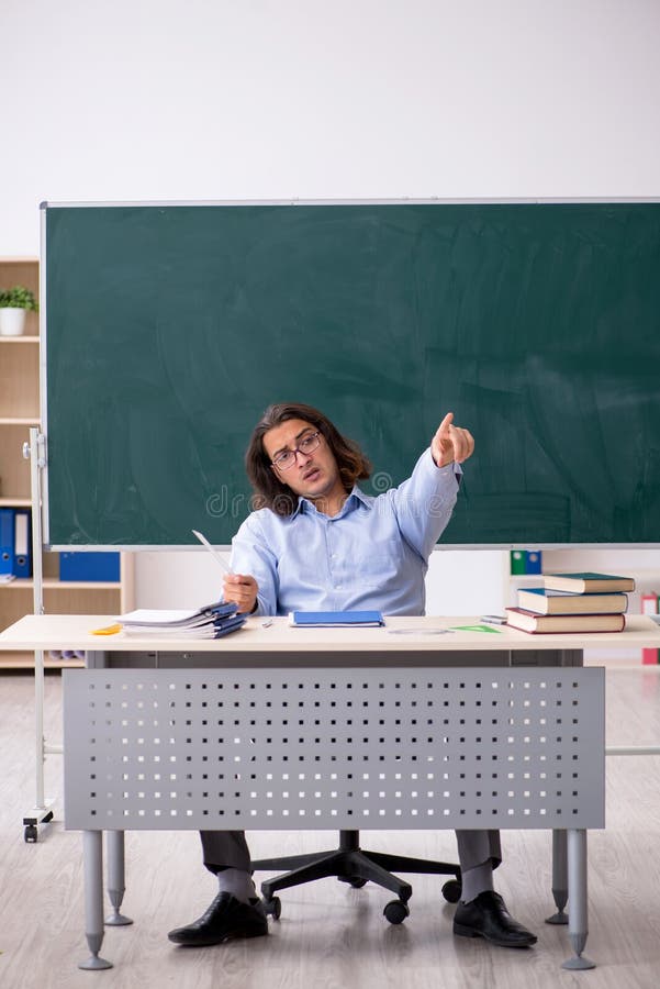 Young Male Teacher in Front of Green Board Stock Photo - Image of ...