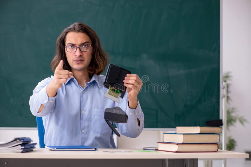 Young Male Teacher in Front of Green Board Stock Image - Image of ...