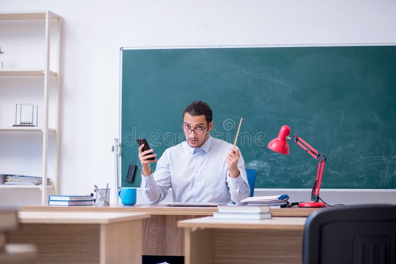 Young Male Teacher in Front of Green Board Stock Image - Image of ...