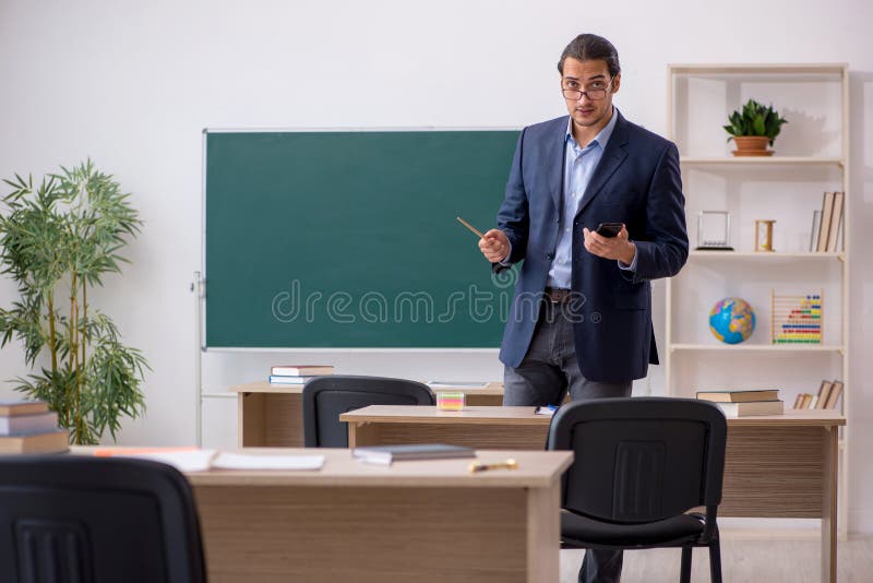 Young Male Teacher in Front of Green Board Stock Photo - Image of board ...