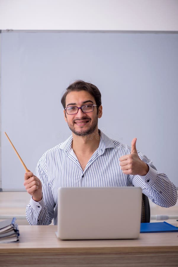 Young Male Teacher Sitting in the Classroom Stock Photo - Image of ...