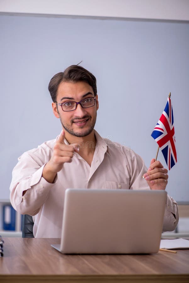 Young Male Teacher Sitting in the Classroom Stock Photo - Image of ...