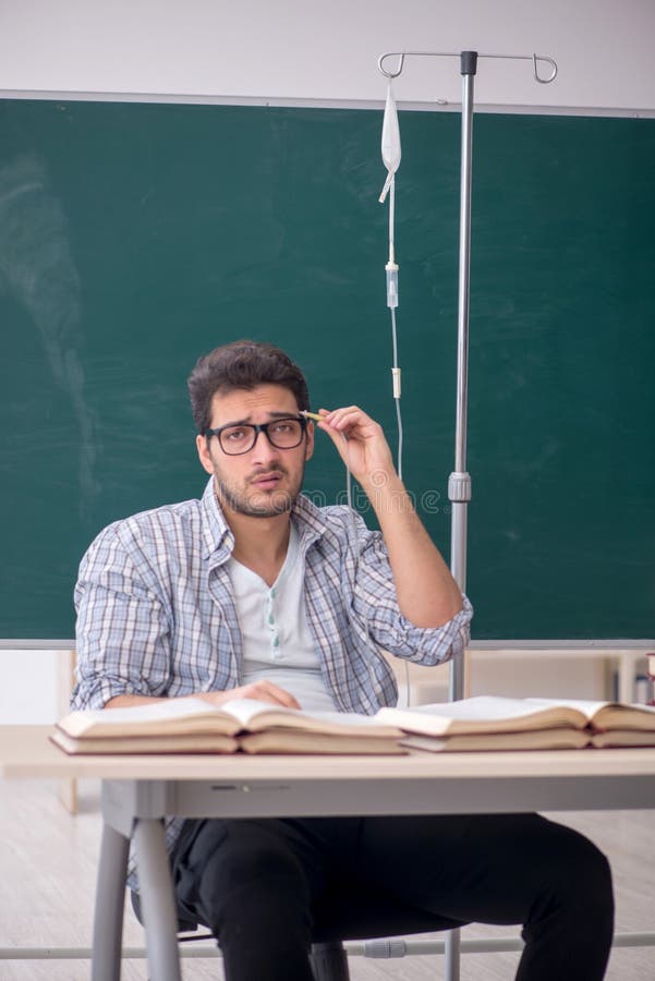 Young Male Teacher Suffering in the Classroom Stock Photo - Image of ...