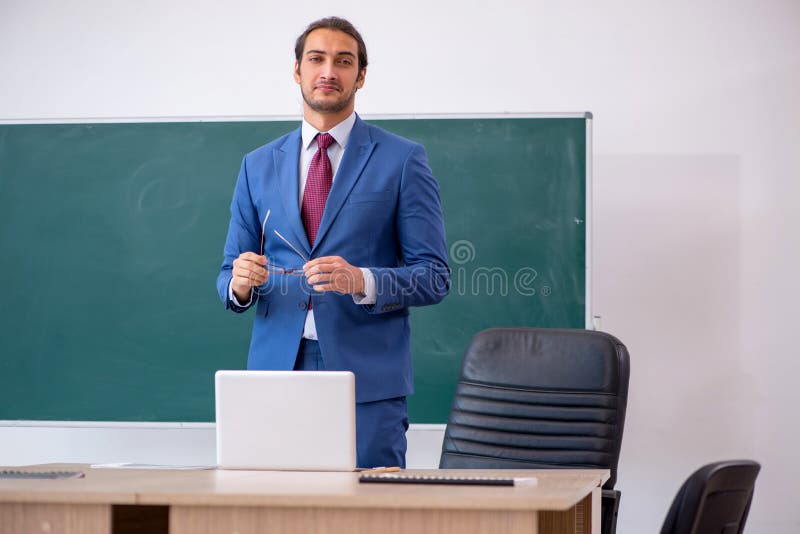 Young Male Teacher in Suit in Front of Green Board Stock Photo - Image ...