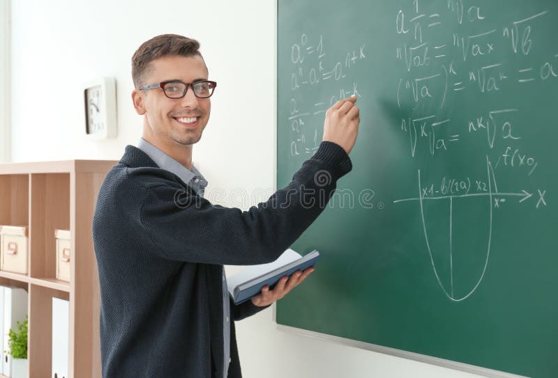 Young Male Teacher Writing on Blackboard Stock Photo - Image of male ... Young Male Teacher Writing on Blackboard Stock Photo - Image of male ...
