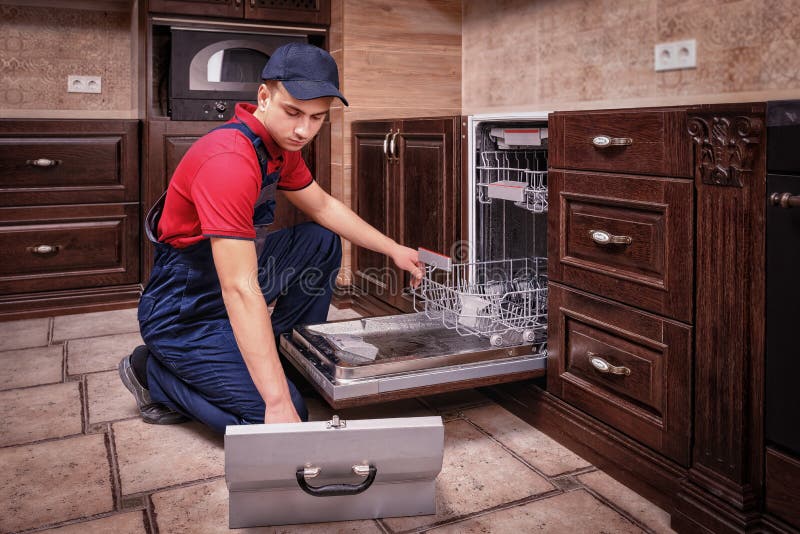 Young Male Technician Repairing Dishwasher in Kitchen Stock Image ...