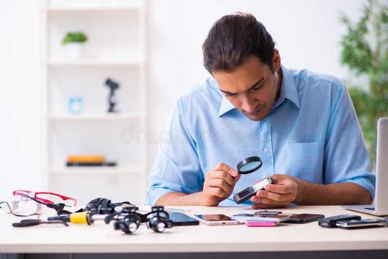 A Man Is Repairing A Mobile Phone. In The Frame, His Hands And Details ...