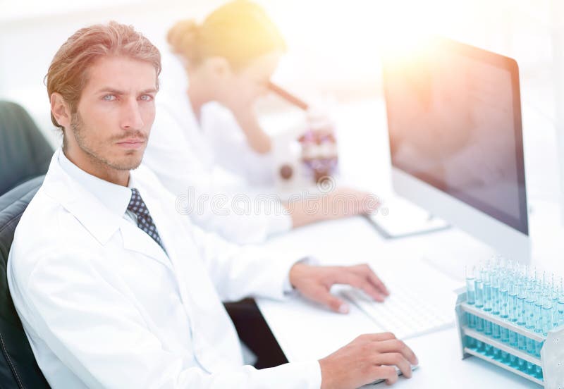 Male Lab Technician Looks at the Sample Under a Microscope Stock Photo ...