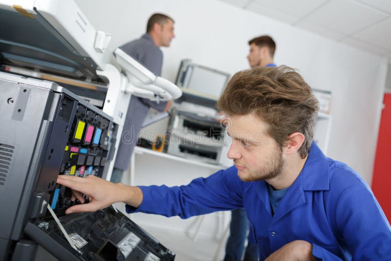 Young Male Technician Working on Photocopier Stock Photo - Image of ...