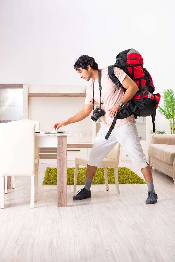 The Young Male Tourist Preparing for Trip at Home Stock Photo - Image ...