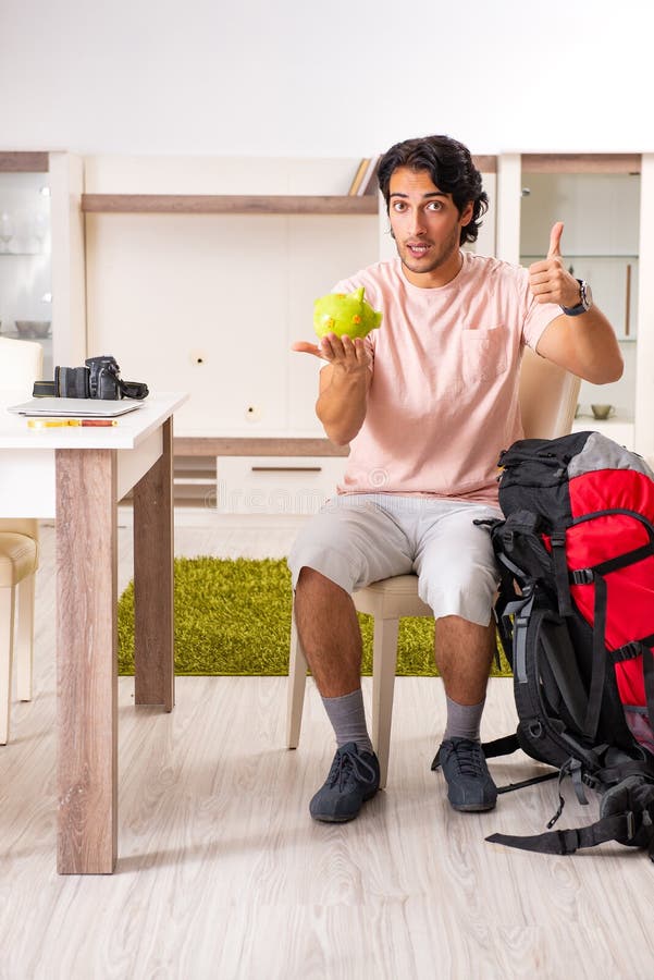 The Young Male Tourist Preparing for Trip at Home Stock Photo - Image ...