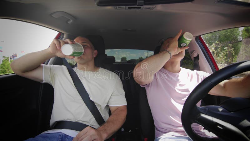 Young Male Twins Drive a Car and Drink Coffee Stock Footage - Video of ...
