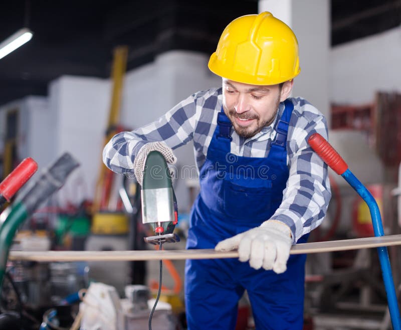Young Male is Using Power Jigsaw for Construction Work Stock Photo ...