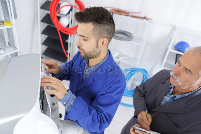 Young Male Worker Fixing Machine Stock Photo - Image of happy ...
