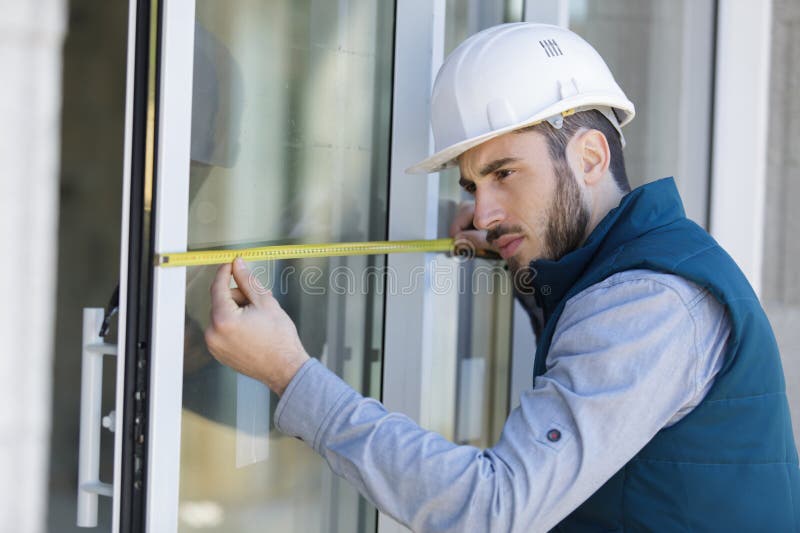 Young Male Worker Measuring Window Stock Image - Image of foreman ...