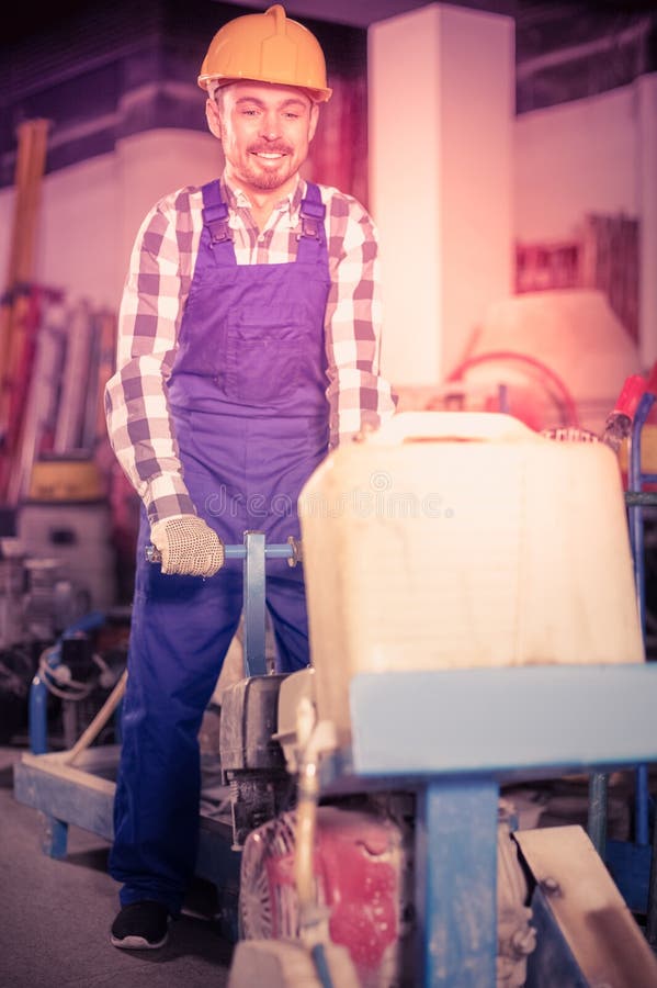 Young Male Worker is Using Gas Saw for Construction Work Stock Image ...