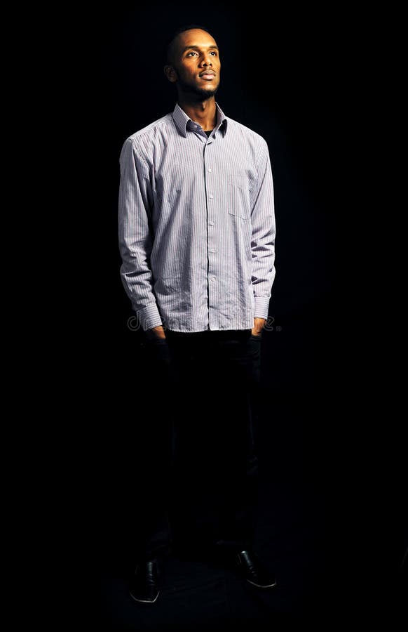 Portrait of a Young African American Man Standing with Legs Crossed ...