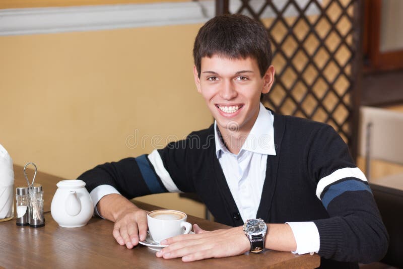Young Man Across Table with Cup of Coffee Stock Photo - Image of design ...