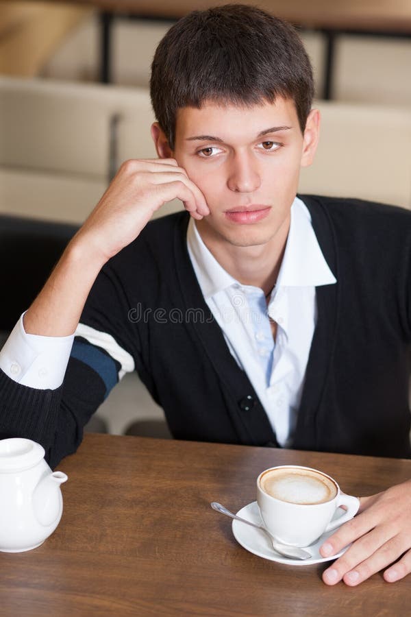 Young Man Across Table with Cup of Coffee Stock Photo - Image of male ...