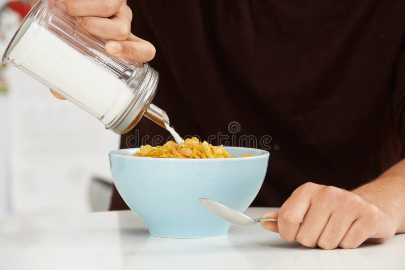 Young Man Adding Sugar To Breakfast Cereal Stock Image - Image of ...