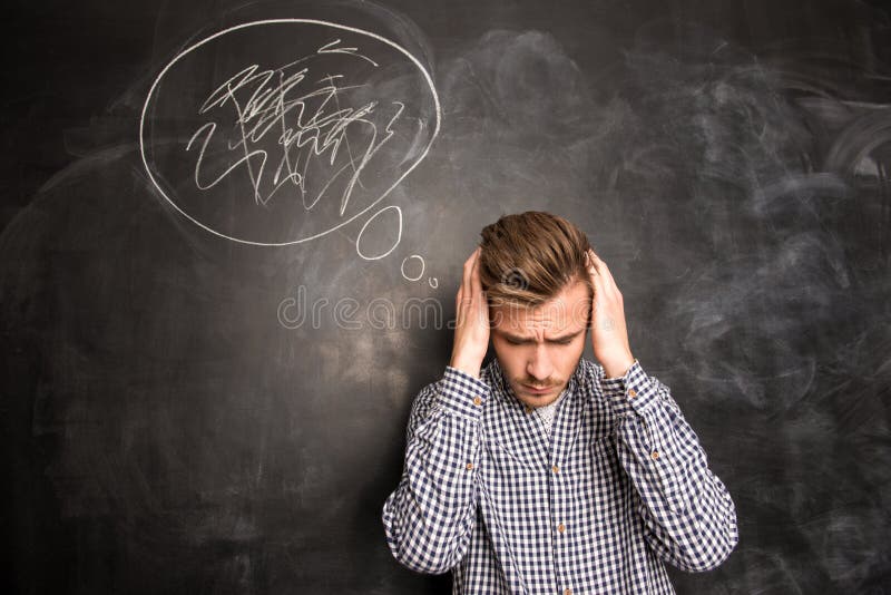Young Man Against the Background of Chalkboard Solving a Problem Stock ...