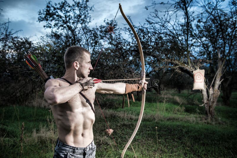 A Young Man Aiming a Bow at a Target Stock Photo - Image of active ...