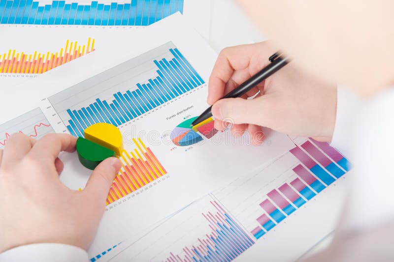 Young man analyzing graphs stock image. Image of desk - 28842701