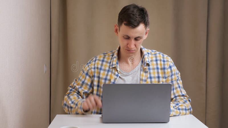 Young Man Angry Typing on Laptop at Table Stock Video - Video of ...