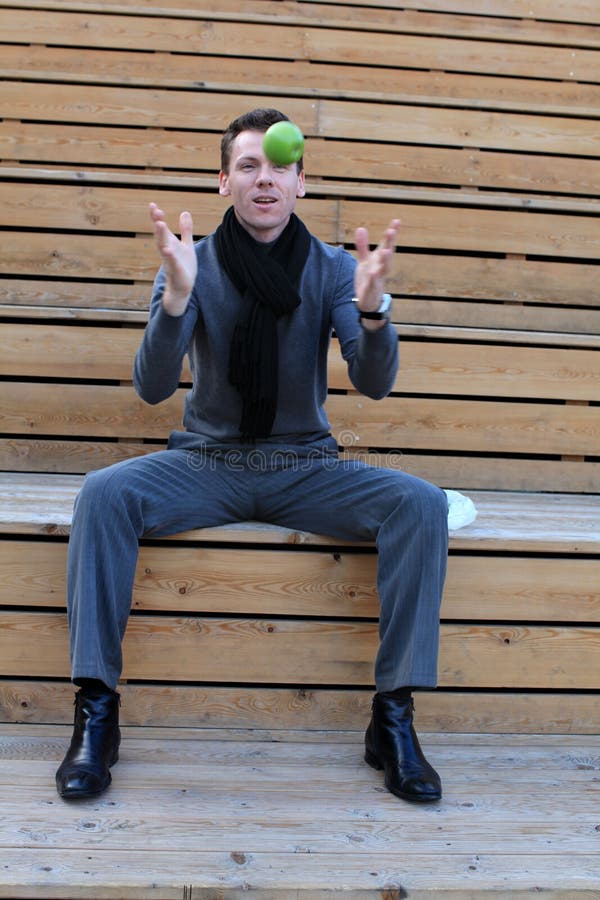 Young man with apple stock photo. Image of sweater, food - 16474528