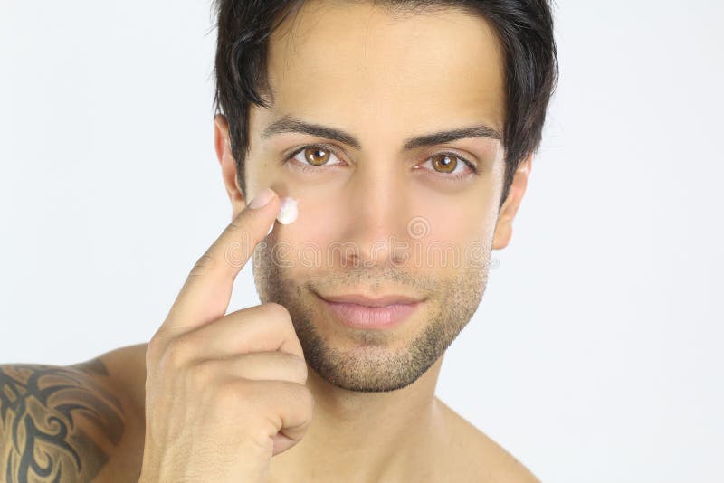 Young man applying cream stock photo. Image of face, cream - 62799380