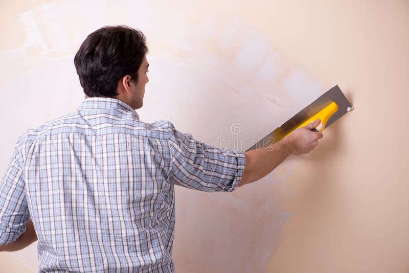 The Young Man Applying Plaster on Wall at Home Stock Image - Image of ...