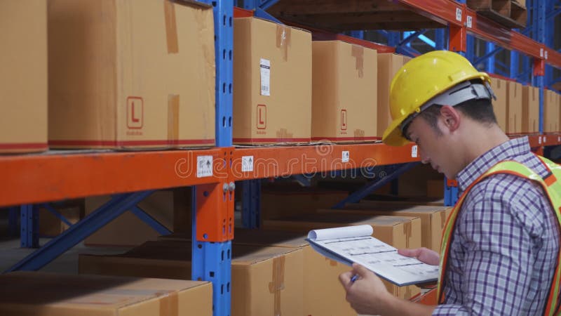 Young Man Applying Shipping Label To Packaging and Check Document and ...
