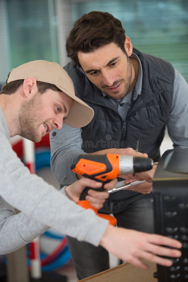 Young Man Apprentice Cutting Wood while Fitting Kitchen Stock Photo ...
