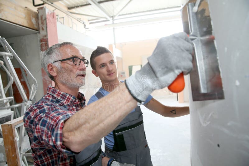 Young Man Apprentice with Professional Plasterer Stock Image - Image of ...