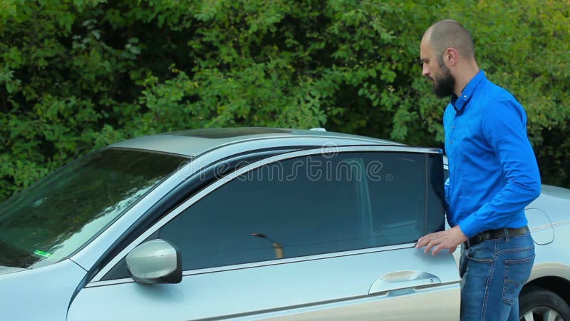 Young Man Approaching and Entering Grey Car Stock Video - Video of ...