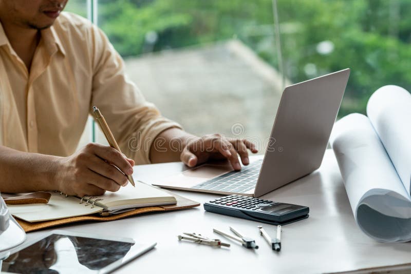 Young Man Architect or Engineer Working at Desk. Stock Photo - Image of ...