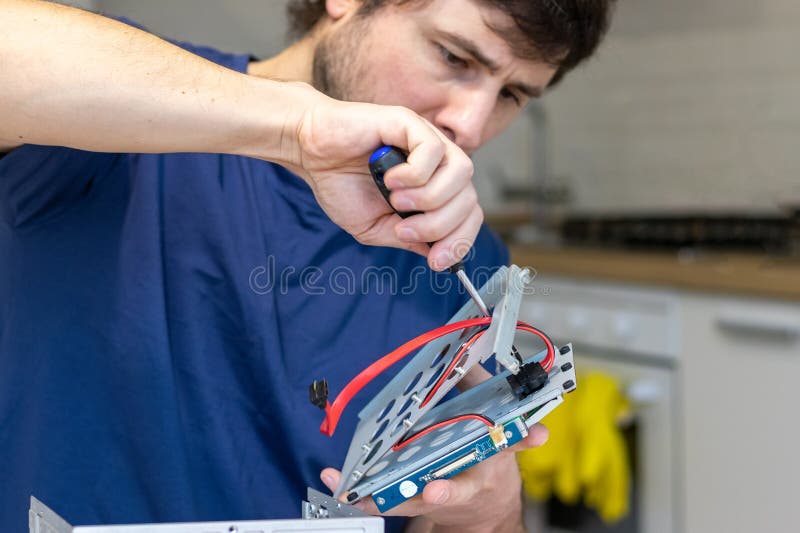 Young Man Assembles Electronic Computer Components with His Own Hands ...