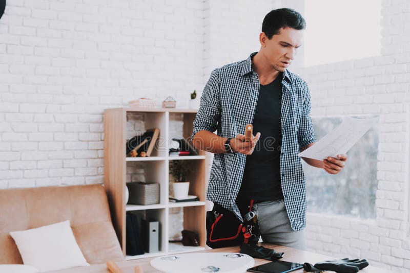 Young Man Assembling Coffee Table and Stools Stock Photo - Image of ...