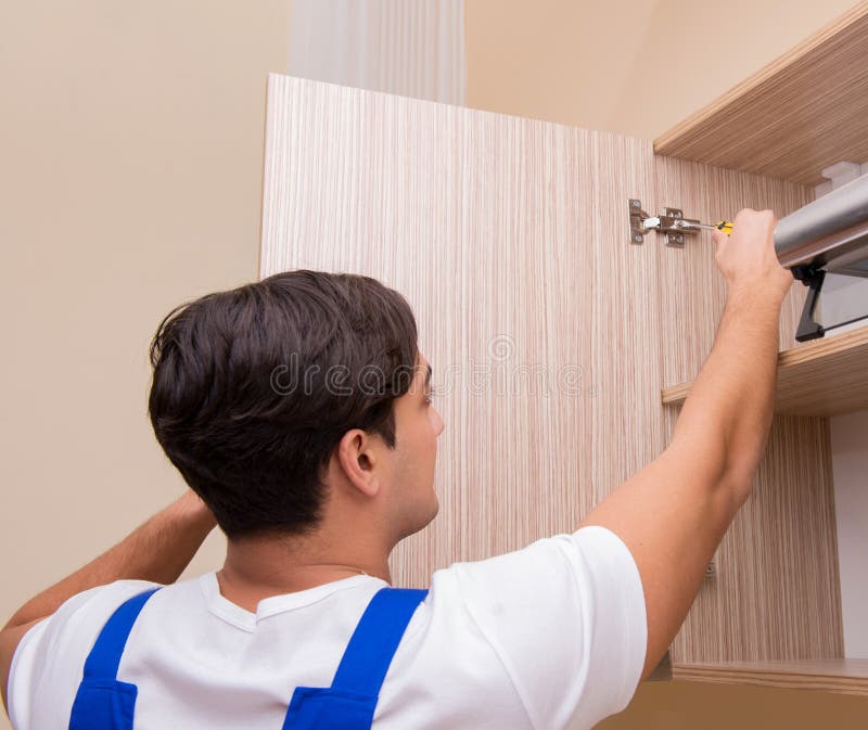 Young Man Assembling Kitchen Furniture Stock Photo - Image of ...